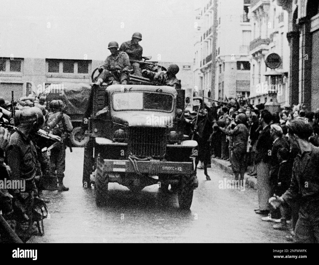 Civilians line a narrow street in Oran, French North Africa, November ...