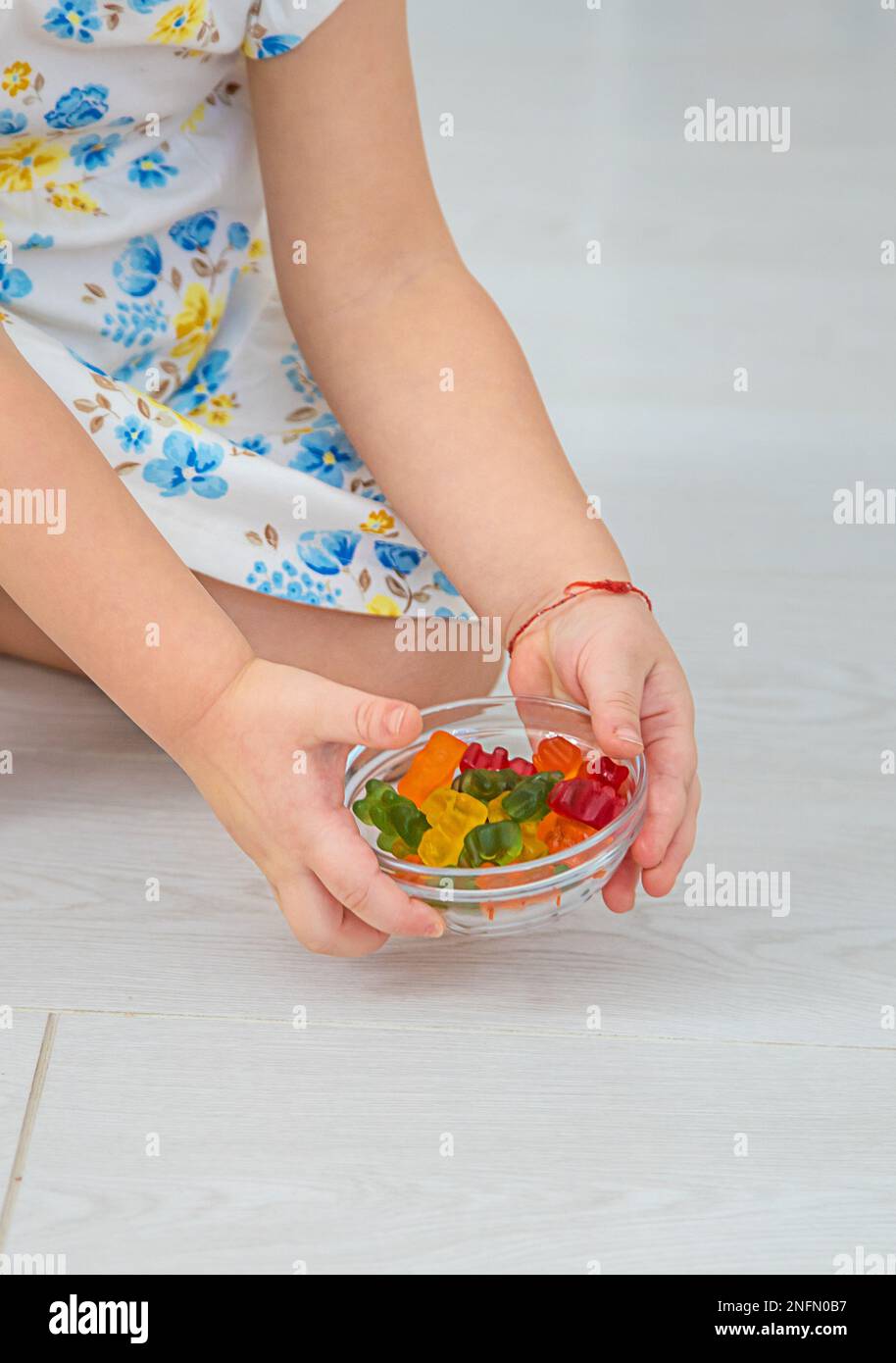 The child eats jelly candies. Selective focus. Kid Stock Photo - Alamy
