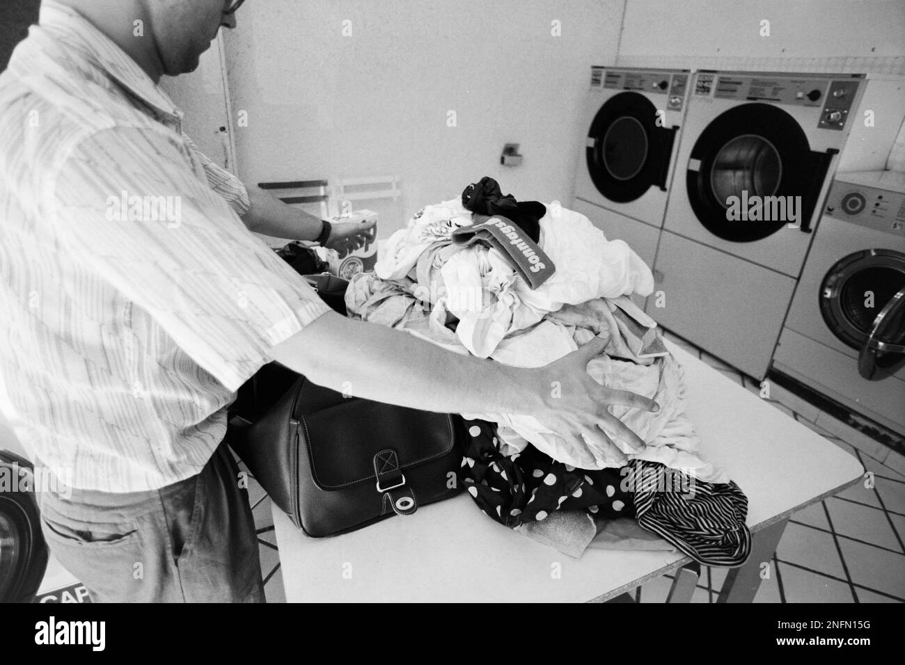 Archives 90ies: A young unmarrried man washes clothes in an automatic ...