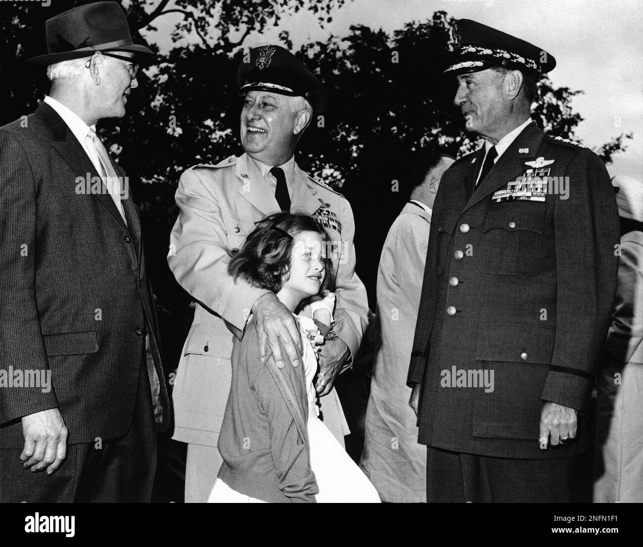 William H. Tunner, center, holds his daughter Suzanne in an informal ...