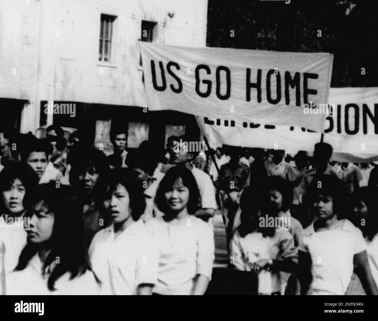 Teenage schoolgirls carry banners like "US Go Home" and "Perfidious ...