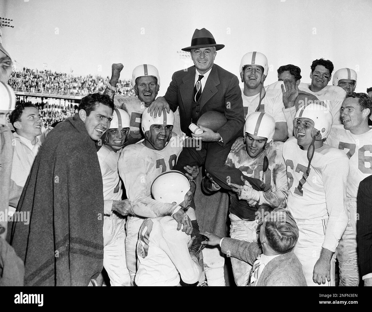 Texas coach J. Blair Cherry is carried on the shoulders of his team off ...