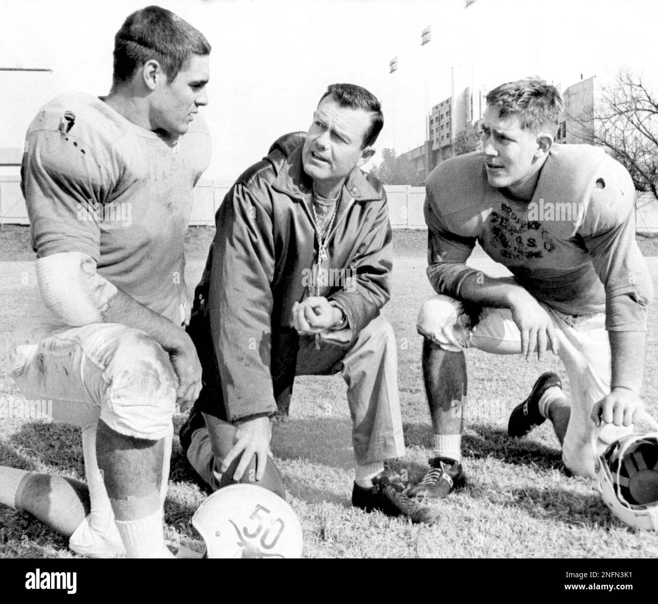 Coach Darrell Royal, center, of the University of Texas, chats with two ...
