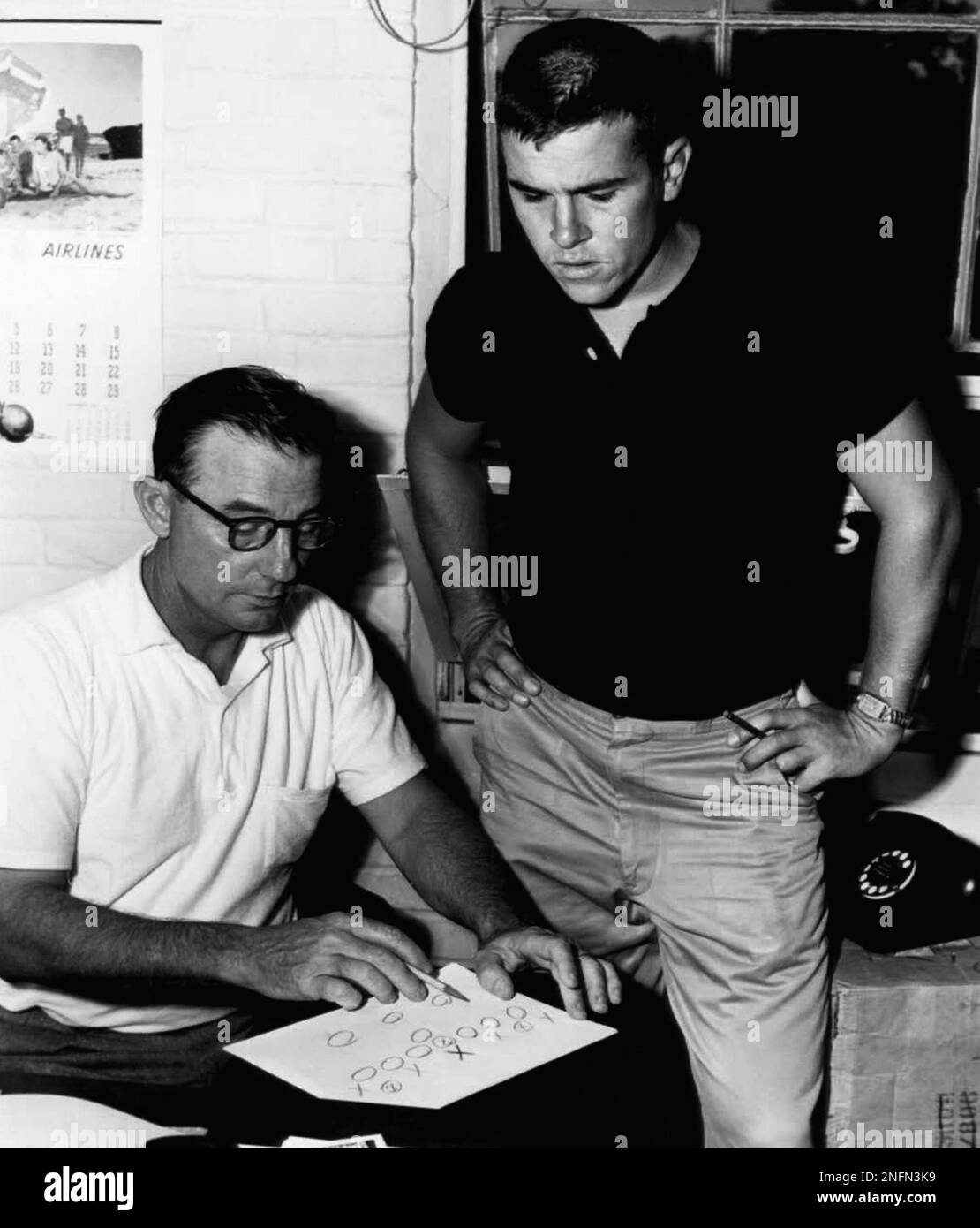 Coach Ed Price shows Texas Longhorn Bunny Andrews how the quarterback ...