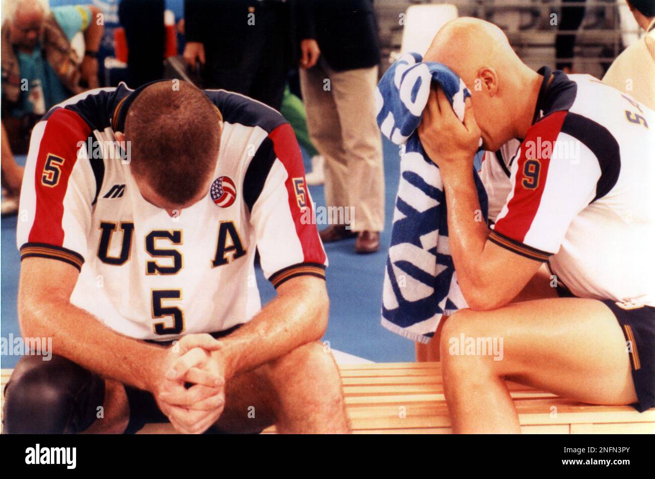 Members of the USA volleyball team sit dejected after their loss to Brazil Friday night, Aug. 7 ...