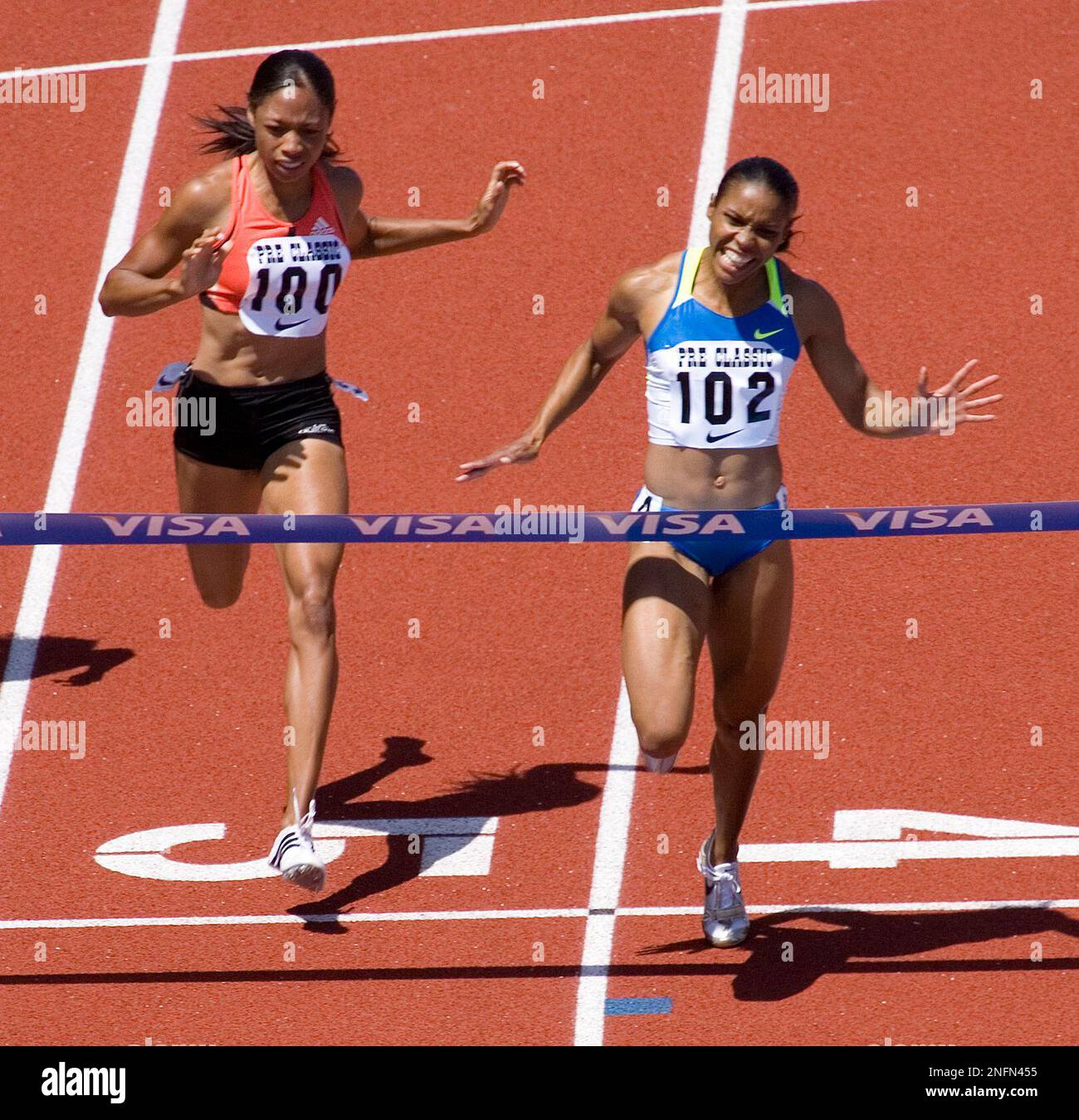 U.S. sprinter Torri Edwards, right, hits the finish line ahead of U.S ...