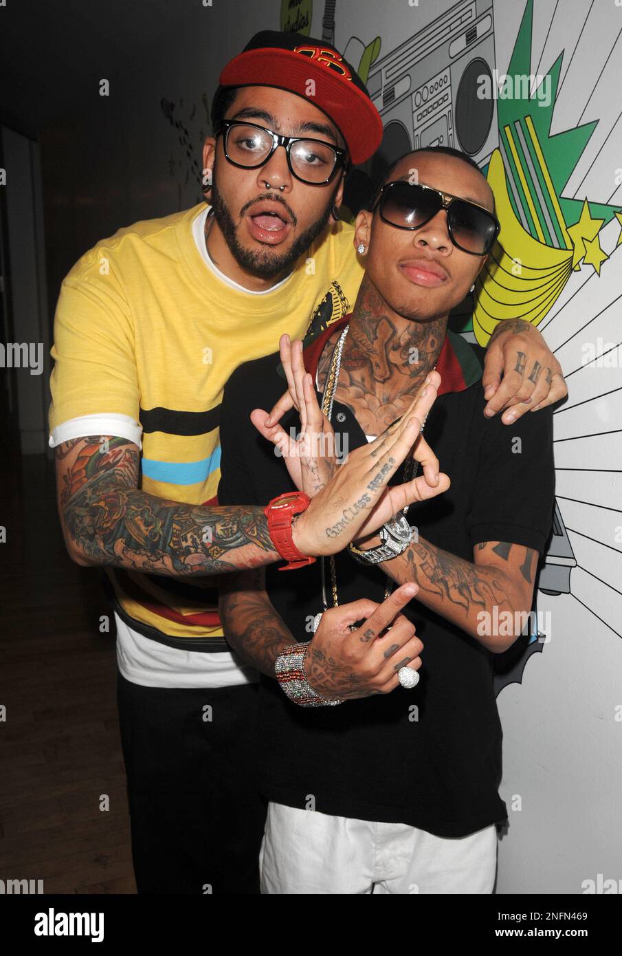 Rapper's Travis McCoy,left, and Tyga pose for pictures backstage at MTV ...