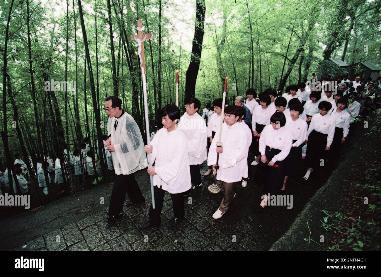 Seminarians lead a procession up the path to the church at the top of ...