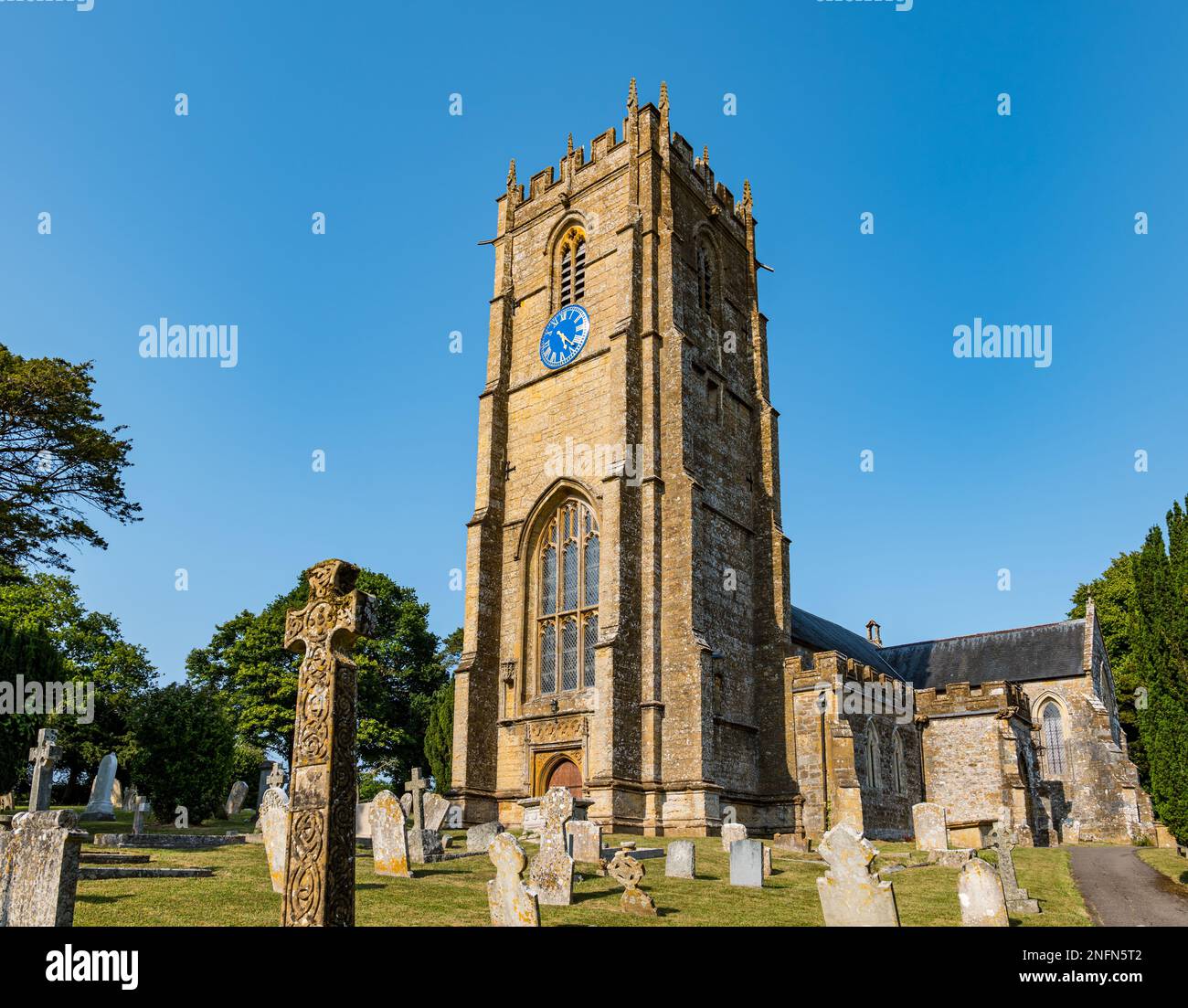 Exterior of St Candida and Holy Cross Church with gravestones in ...