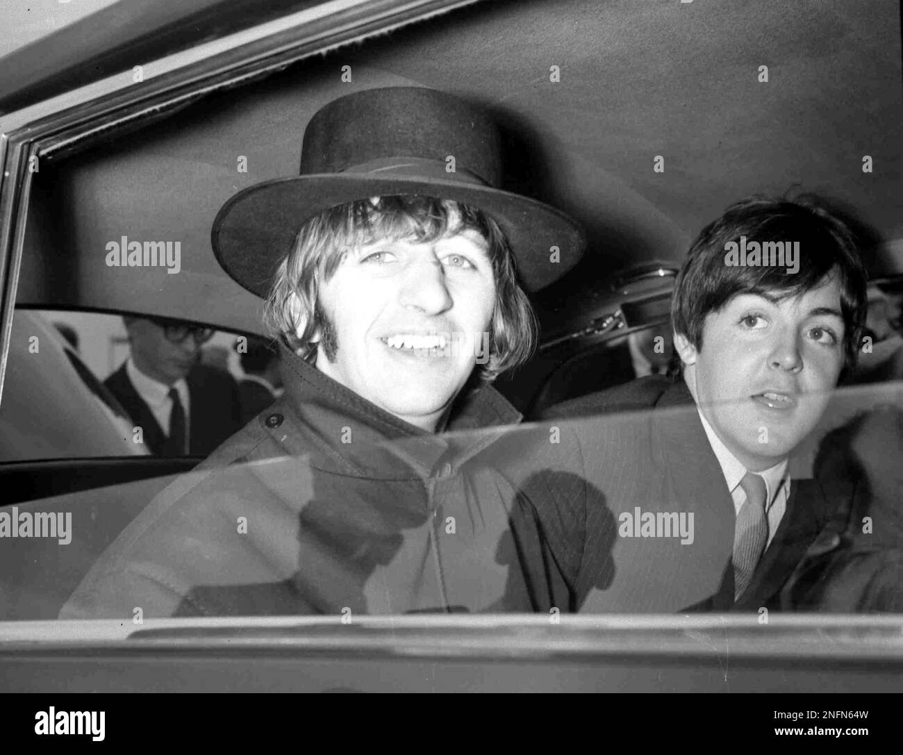 Wearing a toreador-style hat Beatles drummer Ringo Starr, left, grins ...