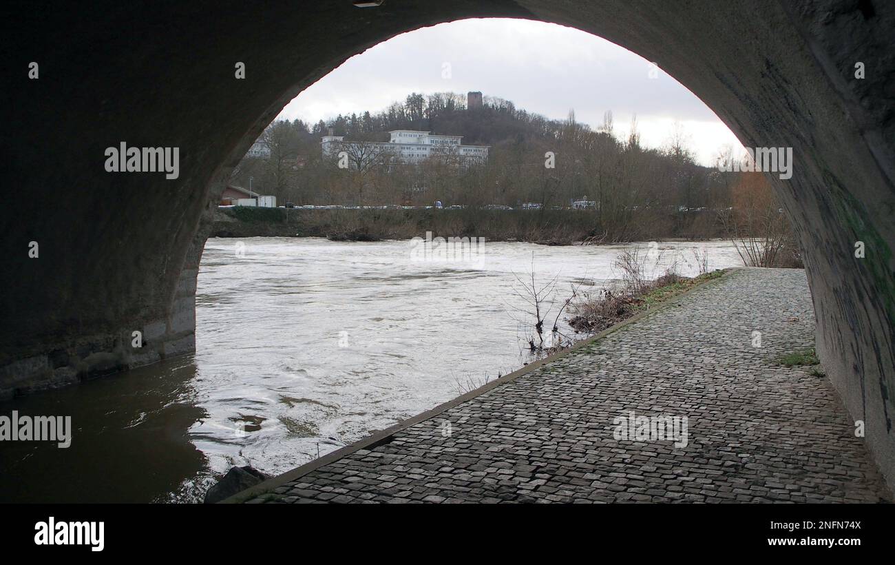 Cobblestone walkway on the right bank of the river Lahn, under the arch ...