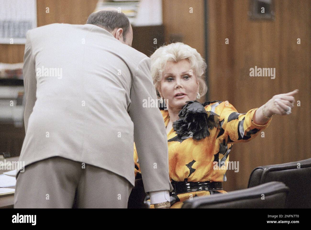 Zsa Zsa Gabor gestures as she confers with her attorney William Graysen ...