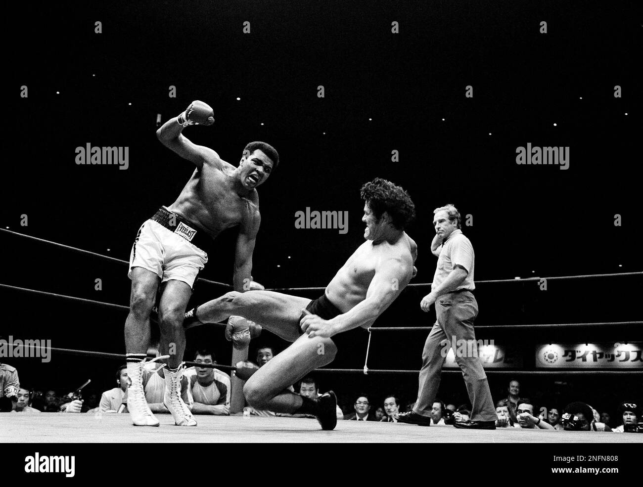 Japanese pro wrestler Antonio Inoki kicks the back of Muhammad Ali's ...