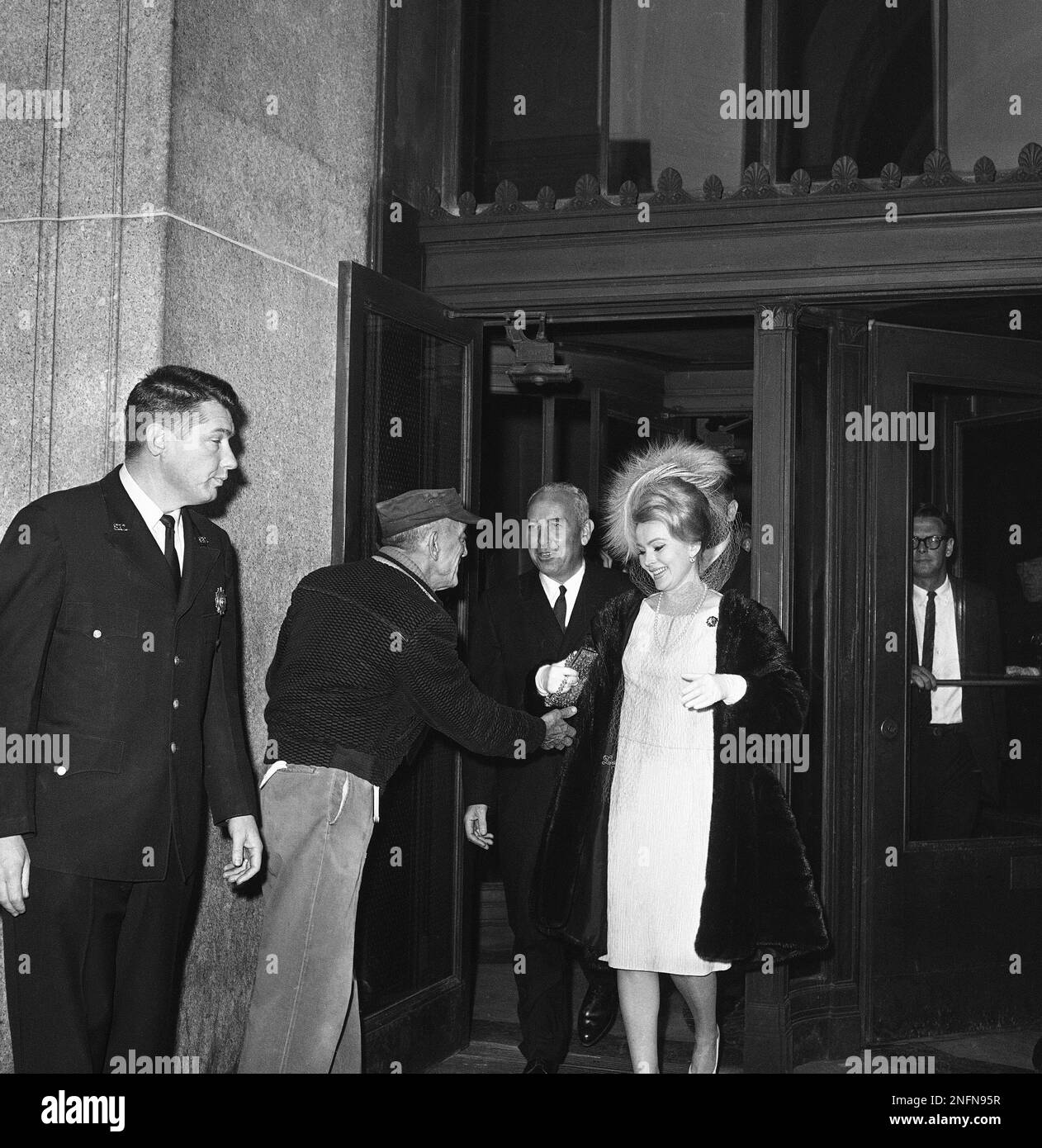 Maintenance man John Poppo extends his hand to congratulate Zsa Zsa ...