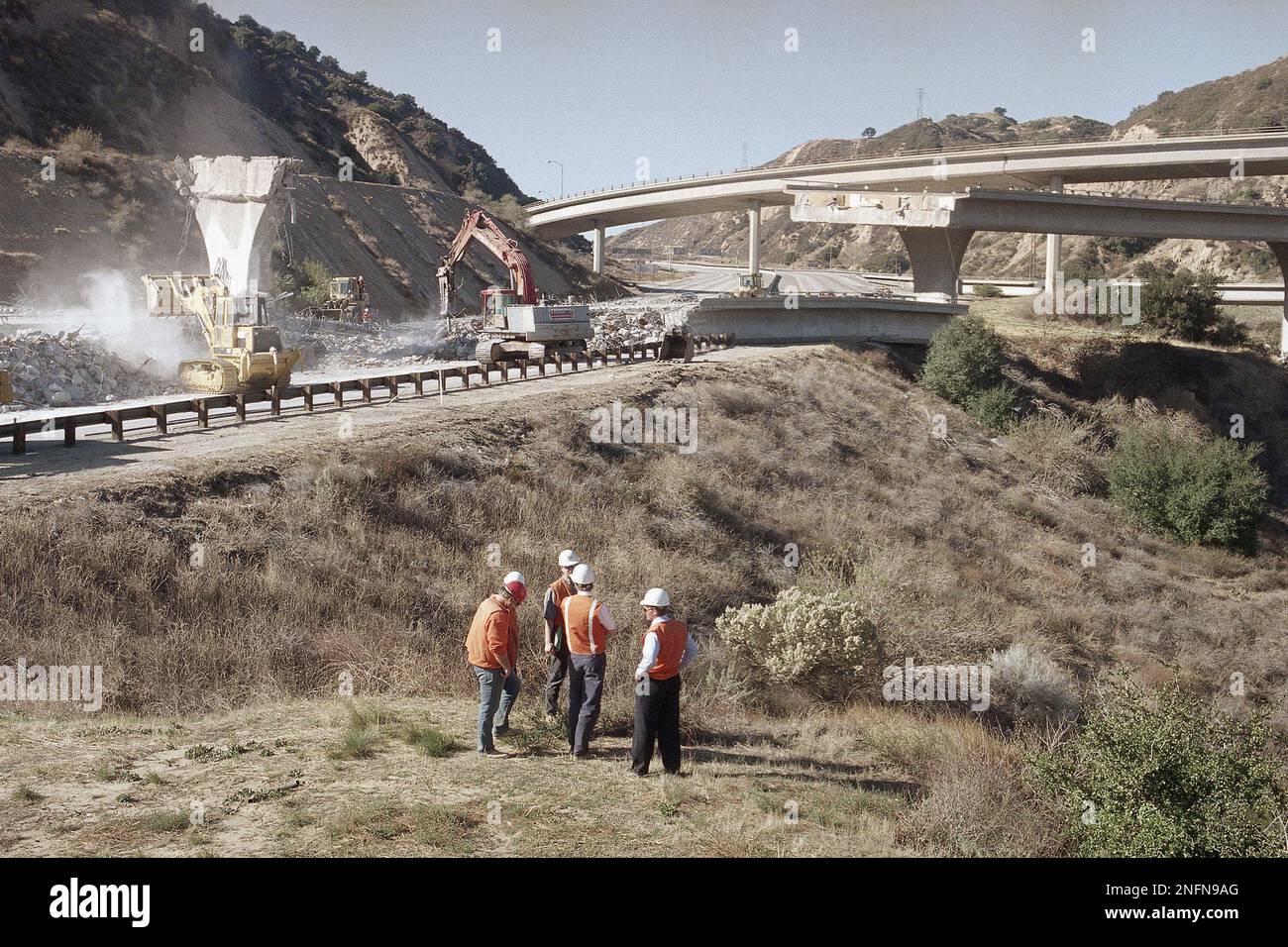CalTrans employees inspect the area where Interstate 5 and state Route ...