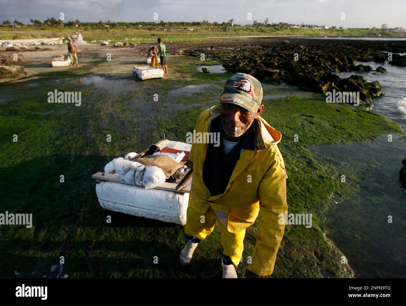 A Cuban fisherman drags his rustic boat in Playa del Chivo near Havana ...