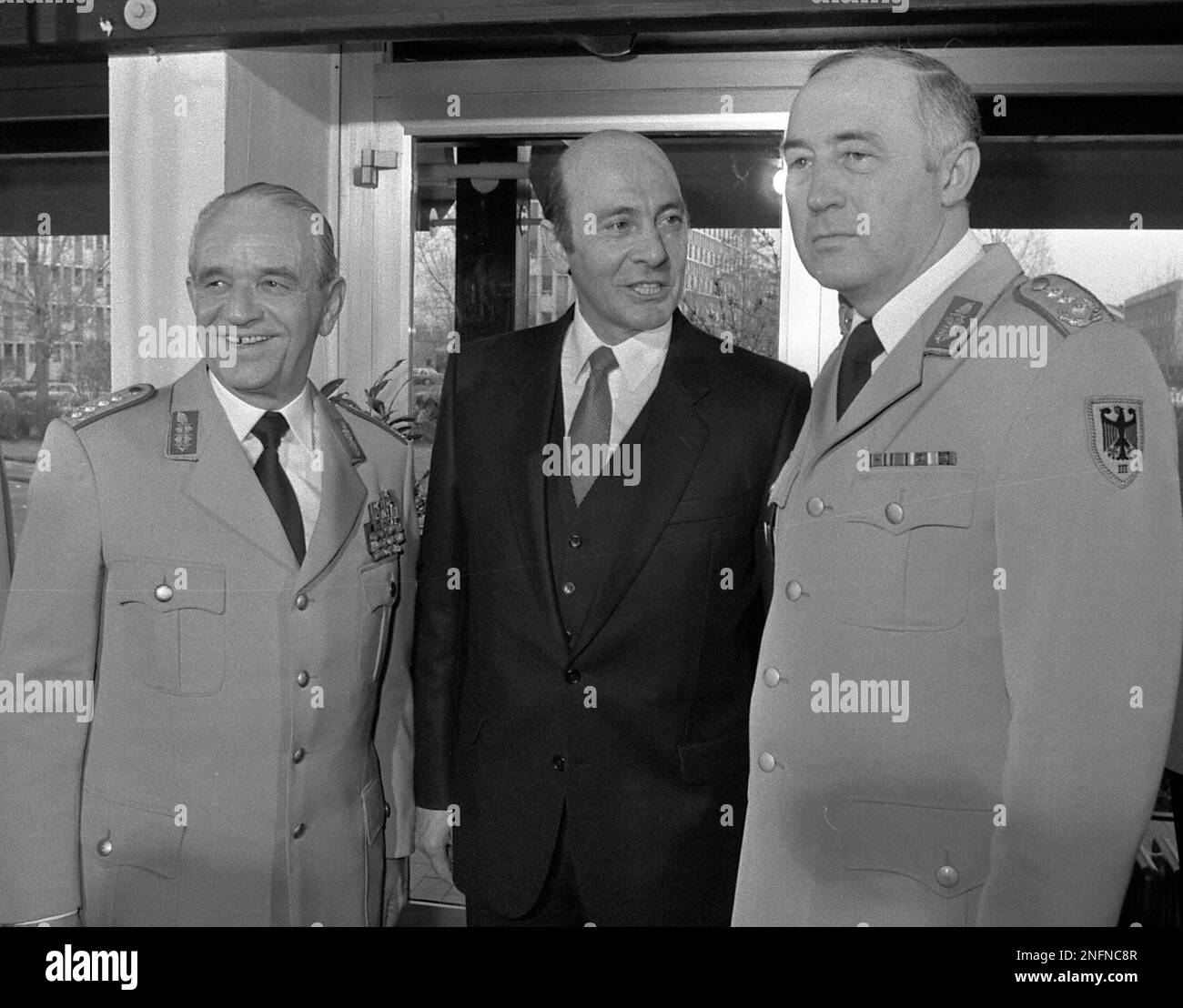 West German minister of defence, Manfred Woerner, chats with parting ...