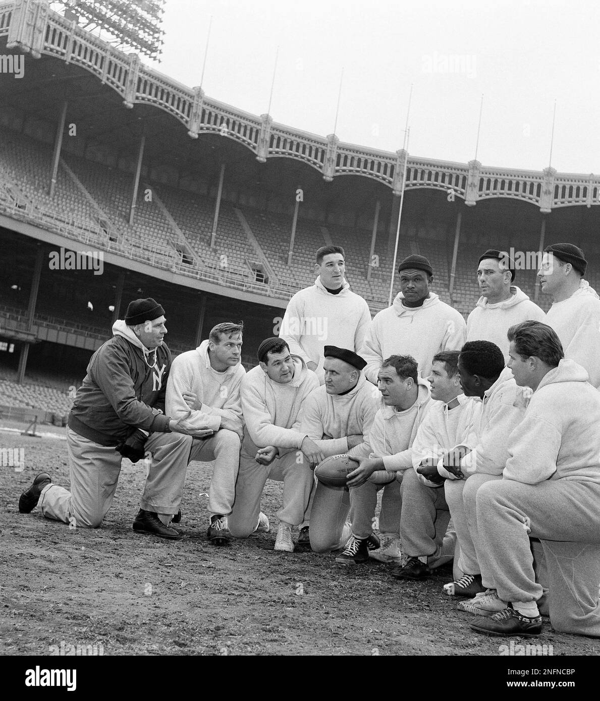 Head Coach Jim Lee Howell, left, poses with his probable offensive team ...