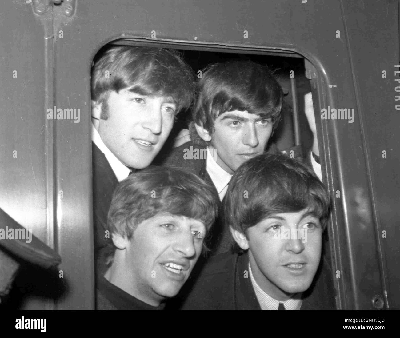 Britain's pop group The Beatles pose in a carriage window of train ...