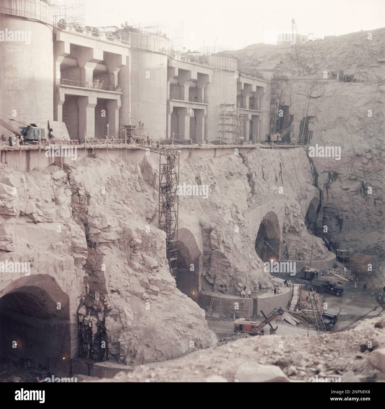 Workers are shown during construction of the Aswan High Dam over the ...