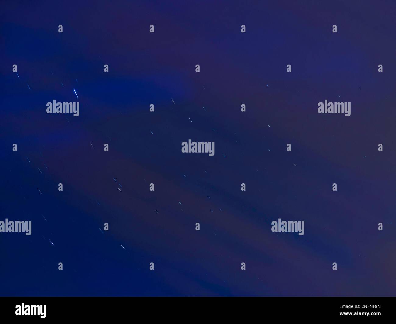 Star tracks on blue clear sky. Long exposure of starry night sky ...