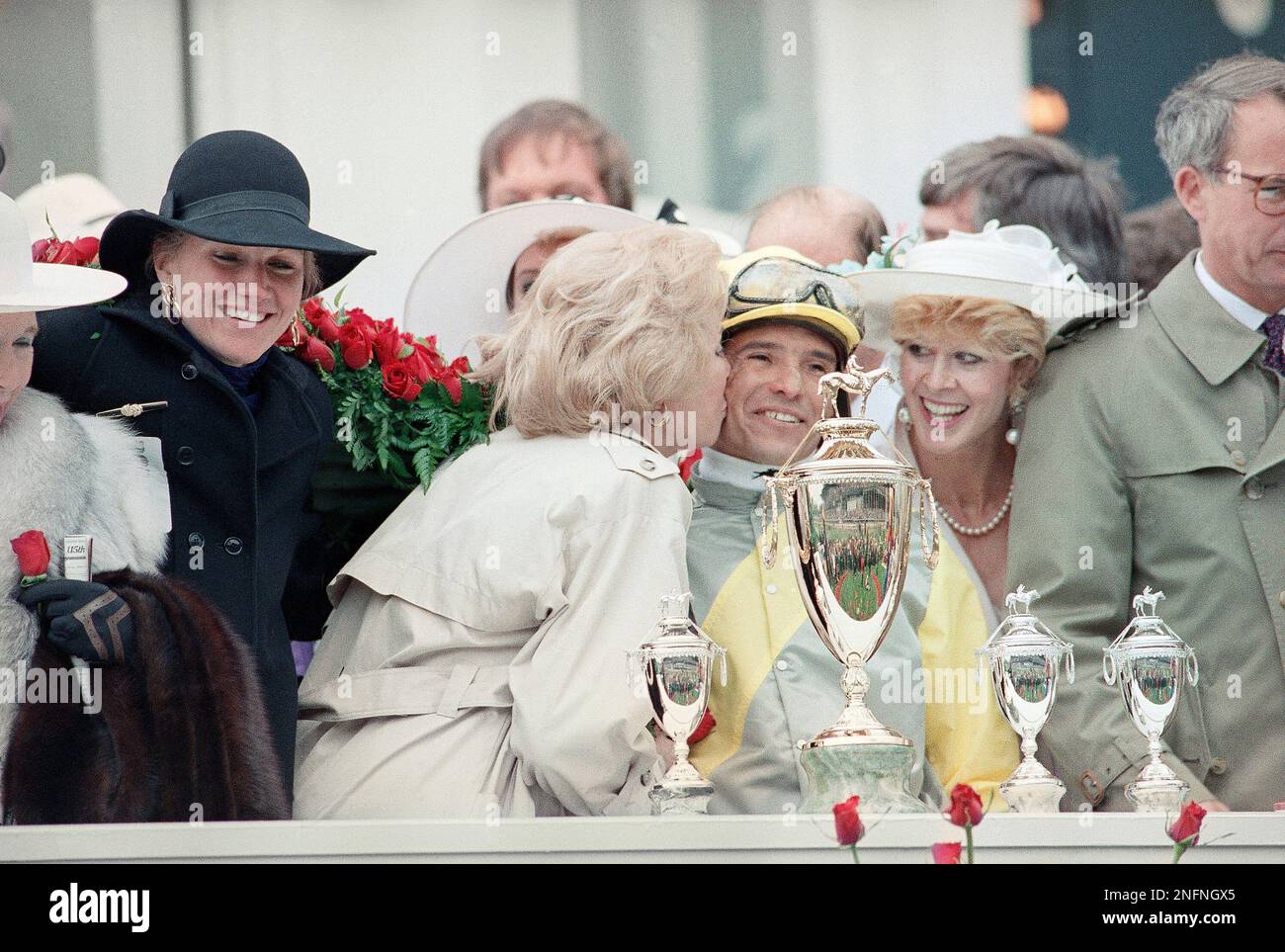 Jockey Pat Valenzuela gets a kiss from Mrs. Peggy Whittingham, wife of ...