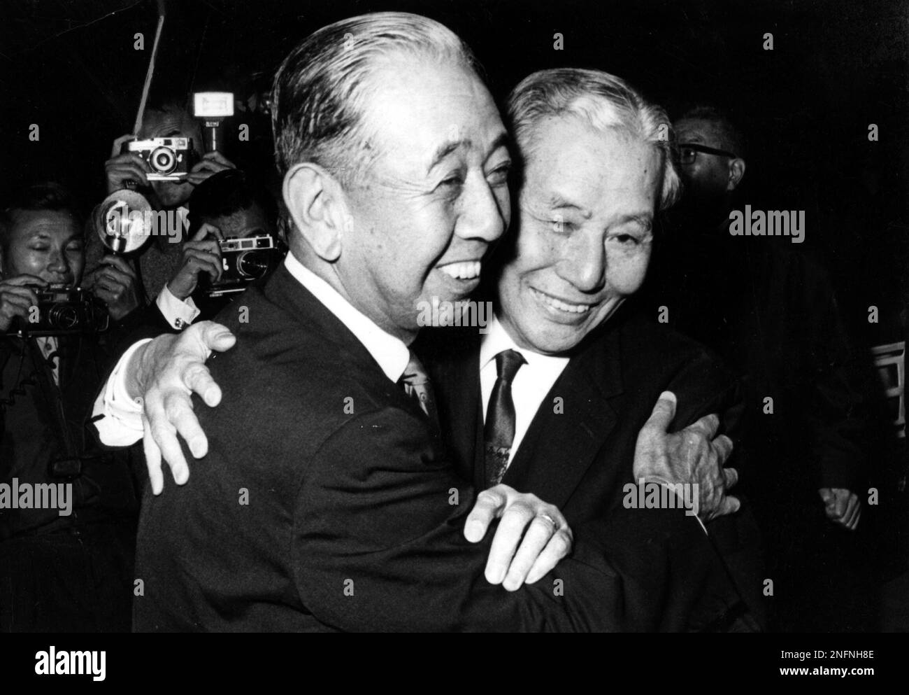 Nobusuke Kishi, former Japanese Prime Minister, left, hugs Presidential ...