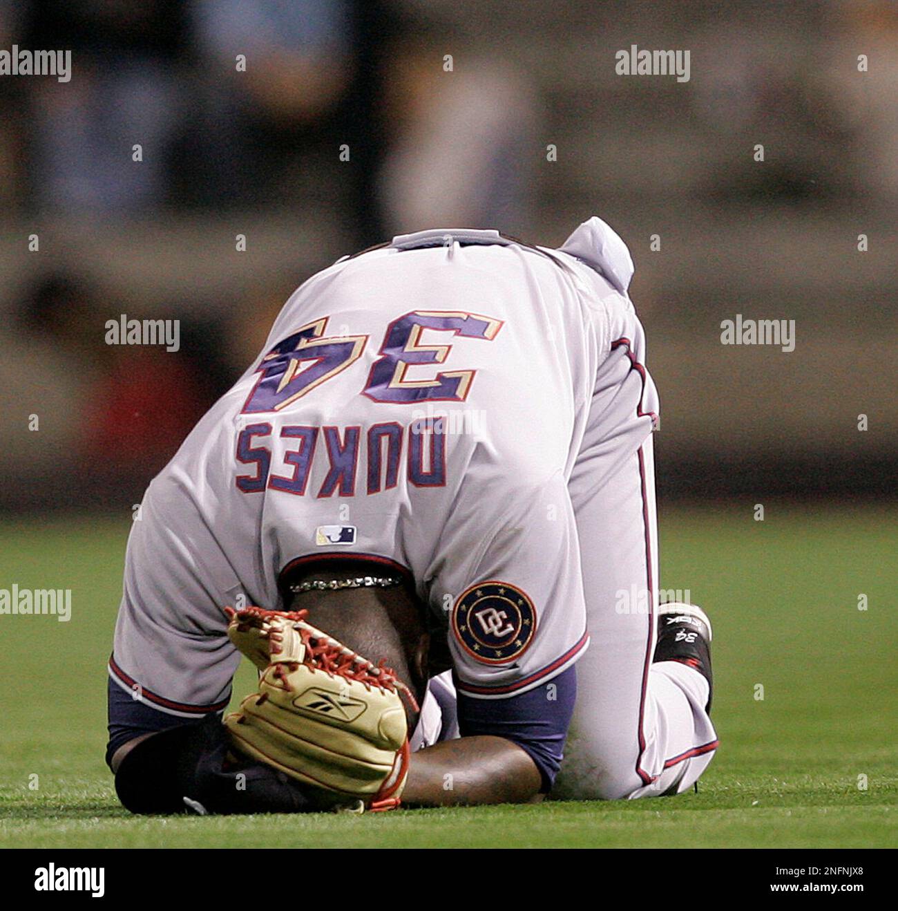 Washington Nationals right fielder Elijah Dukes tries to gather himself ...