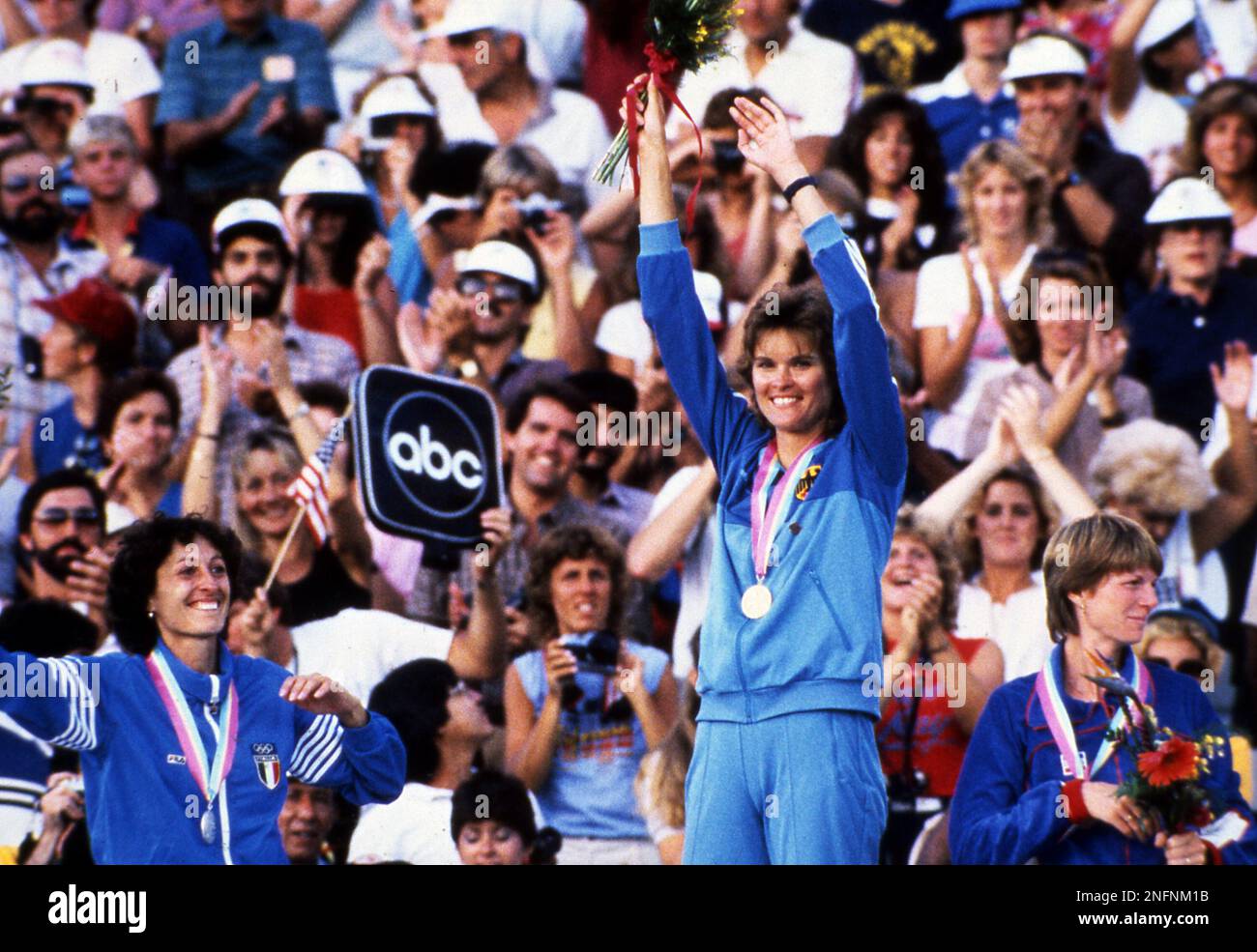 Ulrike Meyfarth of West Germany waves with a bunch of flowers to the ...