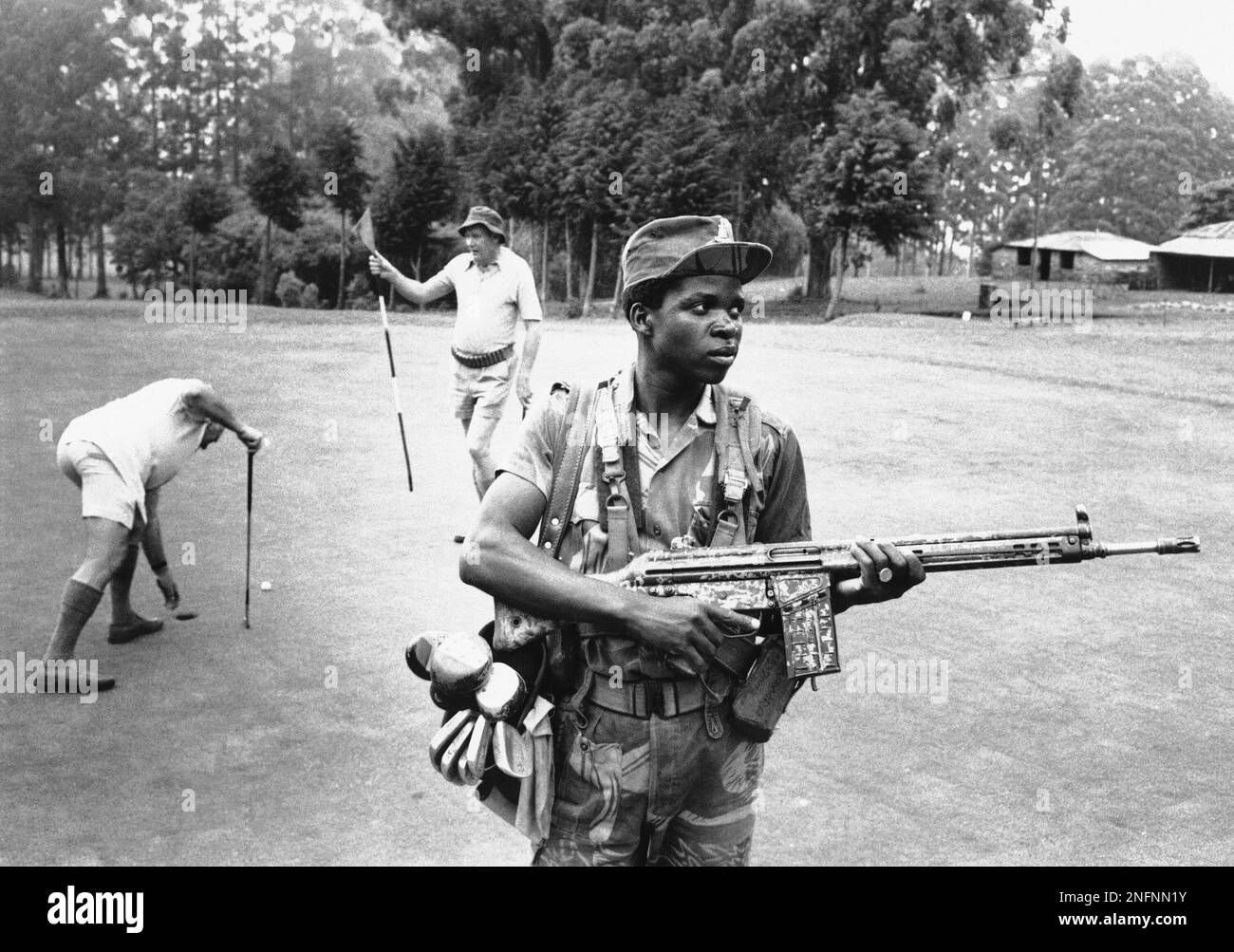 An armed guard provides both service and security on the golf course at ...