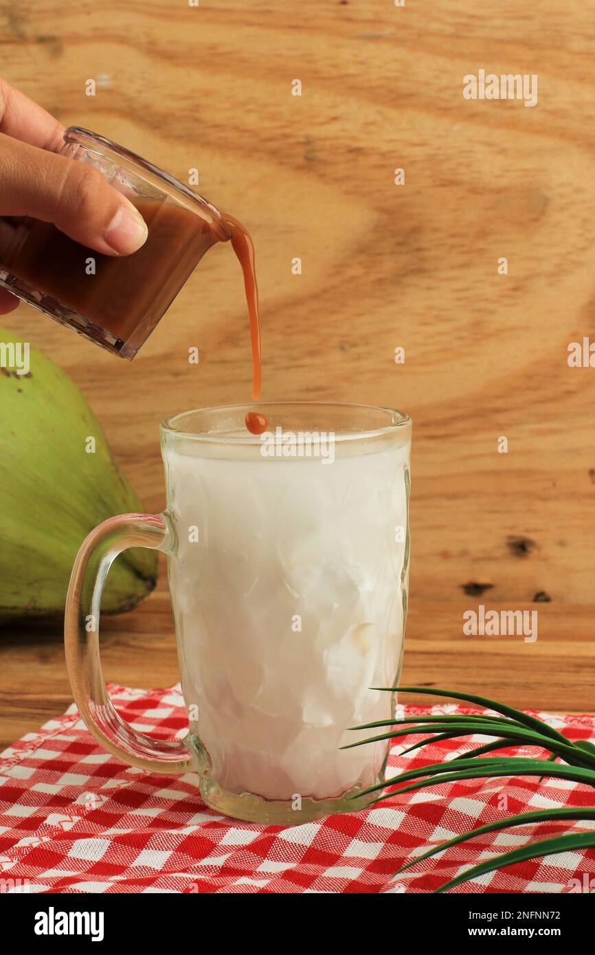 Pour Liquid Palm Sugar to Es Kelapa Muda, Young Coconut Ice, Sweet Cold ...