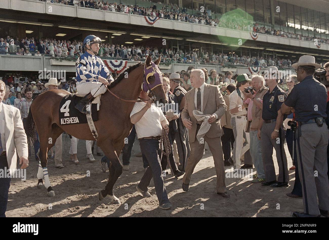 Trainer Jack Van Berg accompanies his horse Alysheba and jockey Chris ...