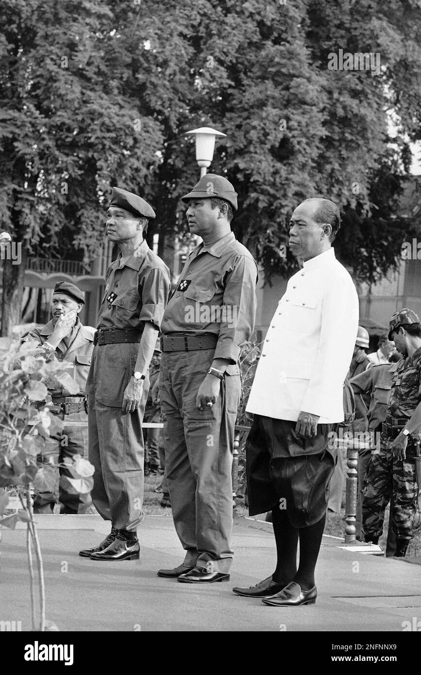 Cambodian government leaders stand at attention during ceremonies on ...