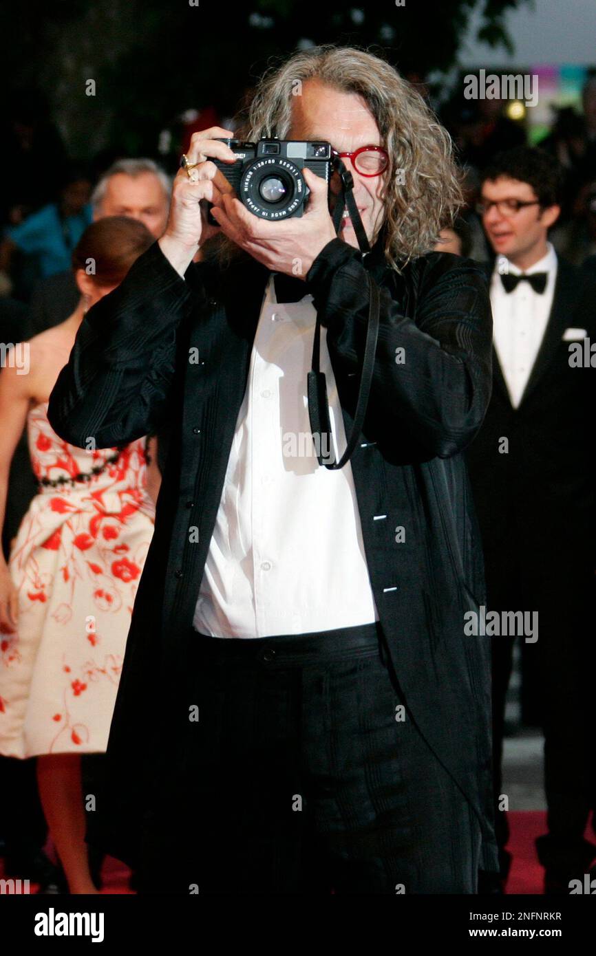 German director Wim Wenders takes a photo as he arrives for the ...