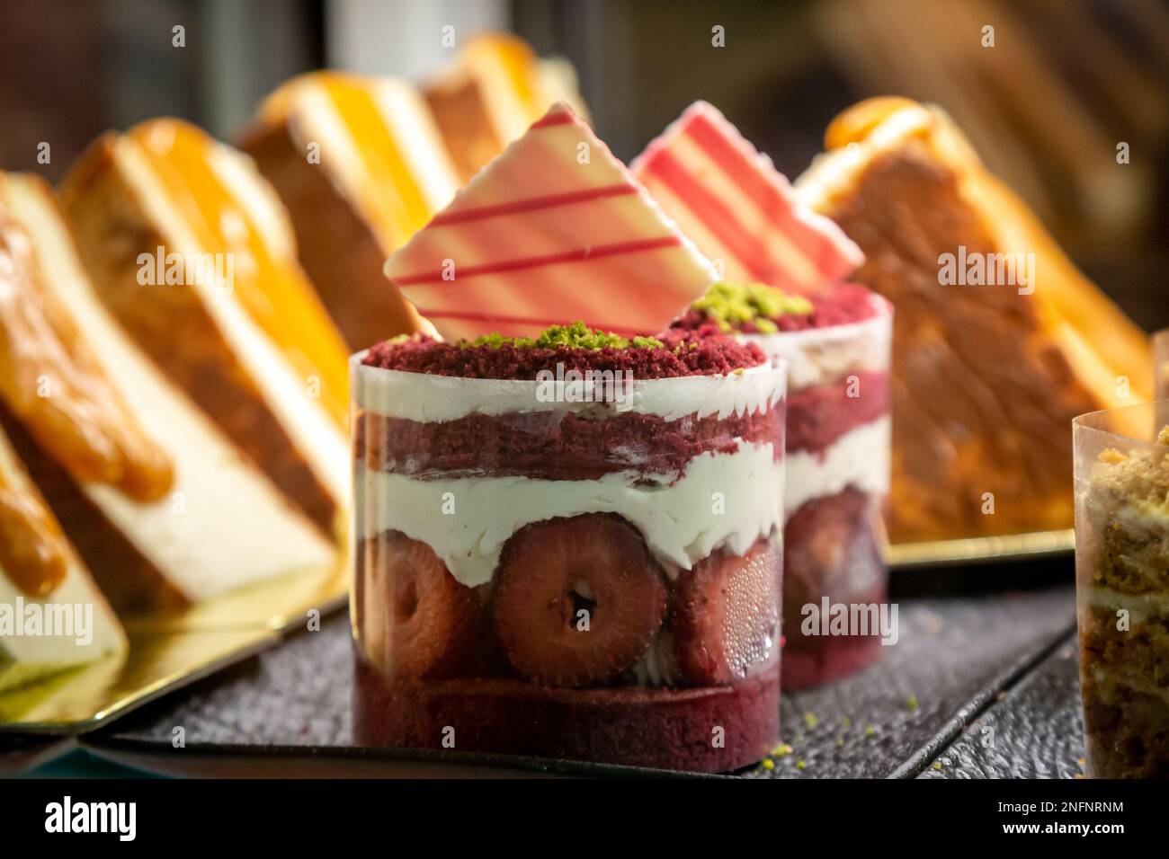 A close up of petty berry desserts in a shop window, with selective ...