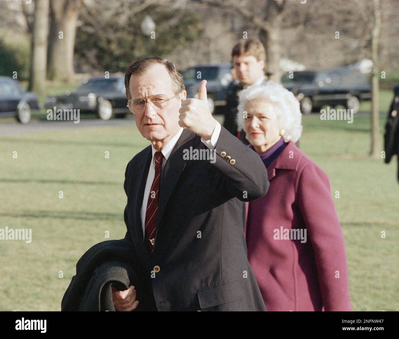 President George H. W. Bush gives a thumbs up sign as he arrives at the ...
