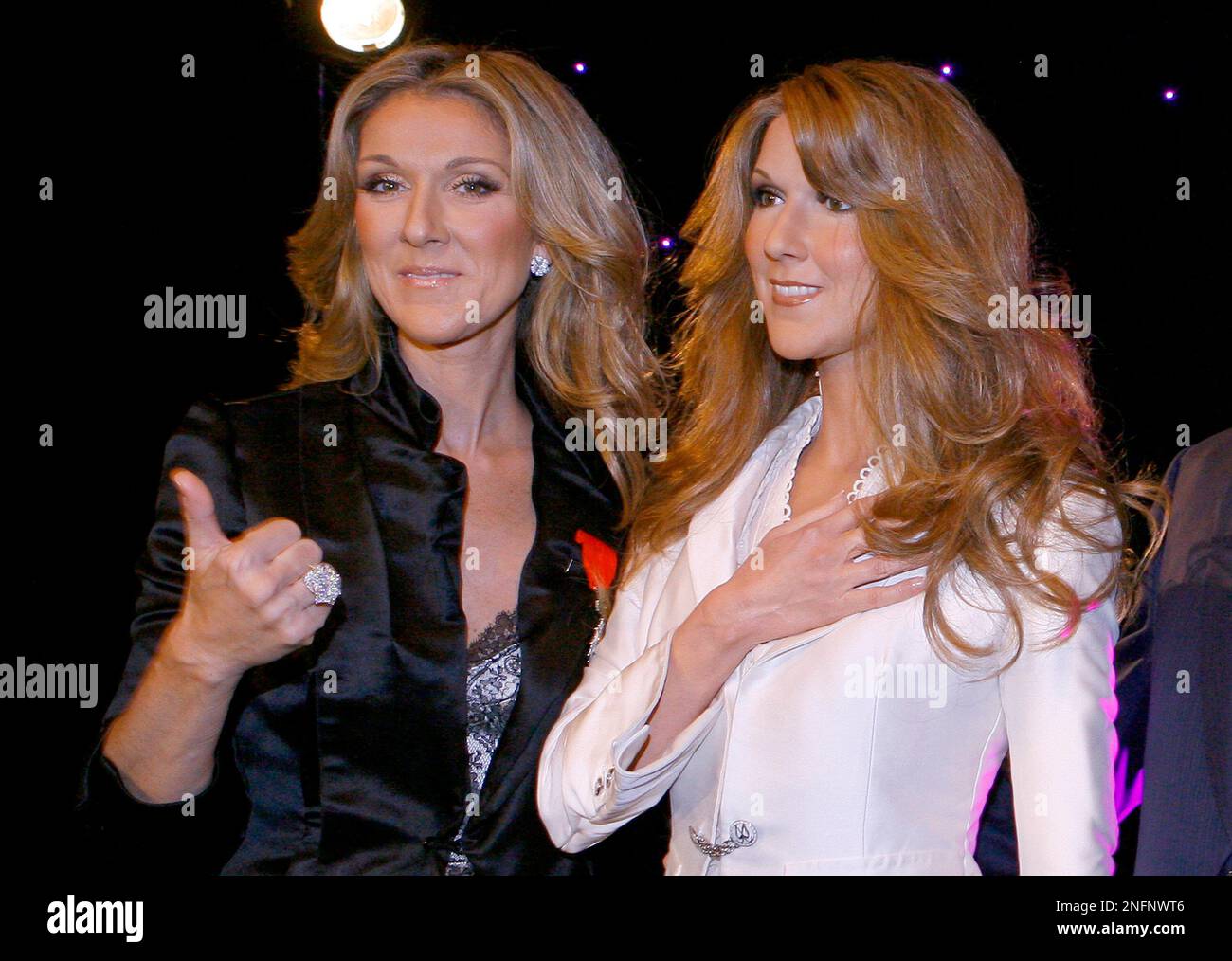 Canadian pop singer Celine Dion poses next to her life-size wax model ...