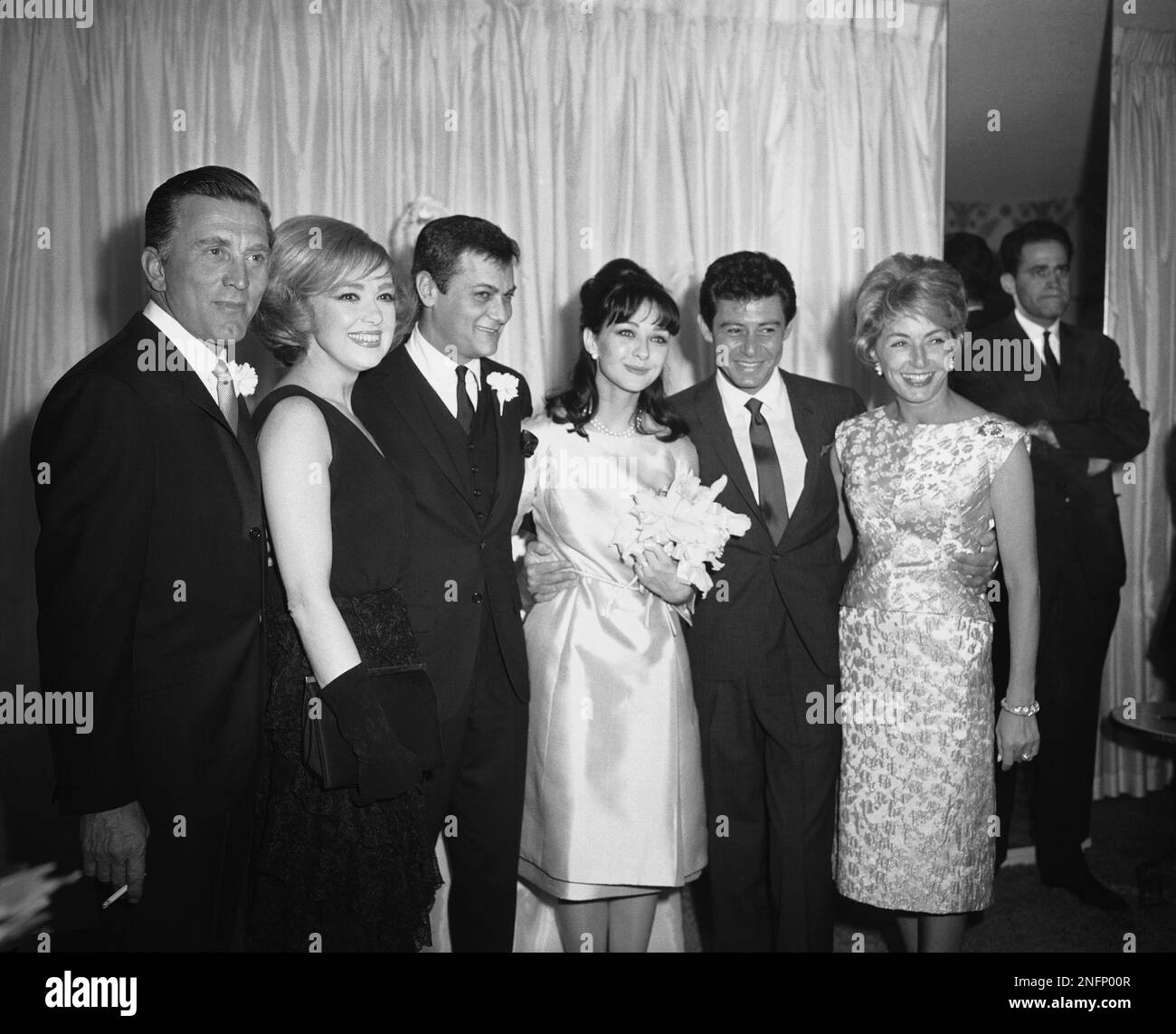 Actor Tony Curtis, 37, and Christine Kaufmann, 18, pose with a few ...