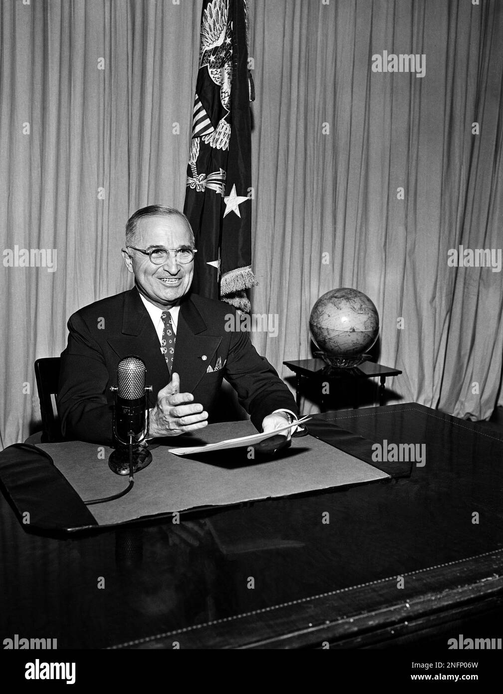 President Harry Truman sits before the microphone at the White House on ...
