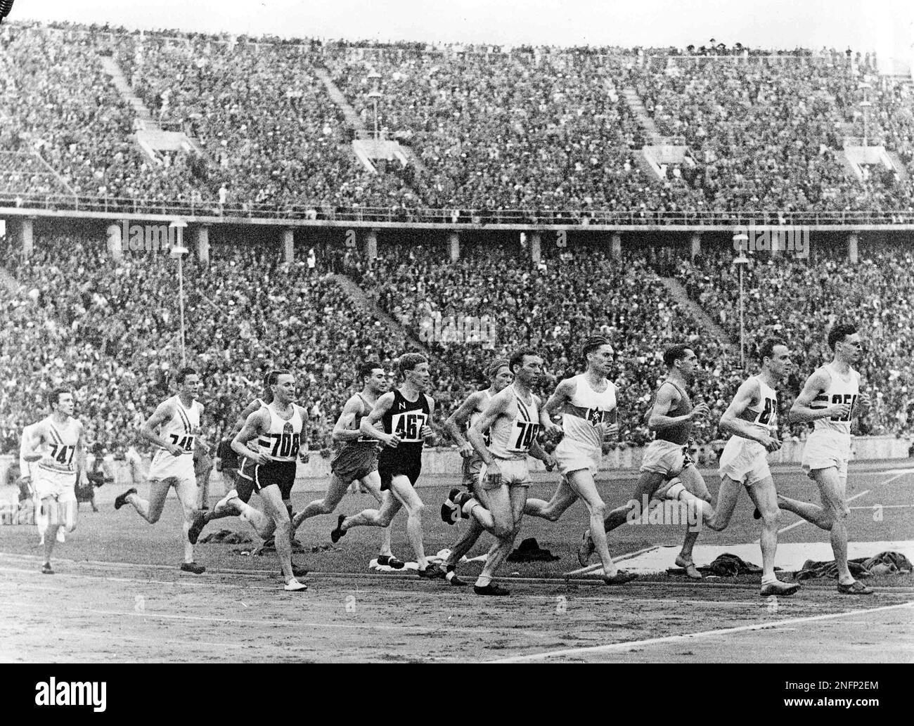 Athletes complete the first lap of the Final of the men's 1,500 metres ...