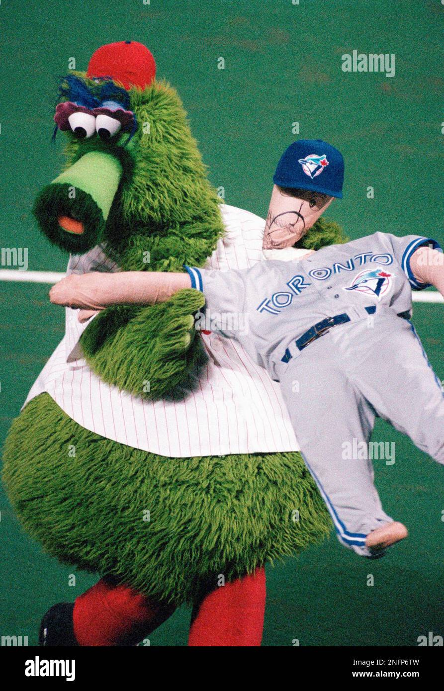 The Phillie Phanatic holds a doll dressed in a Toronto Blue Jays ...