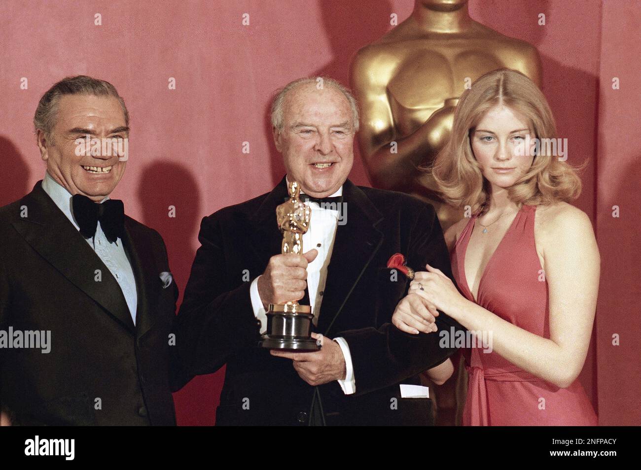 Actor-director John Houseman holds his Oscar as he poses with actor ...
