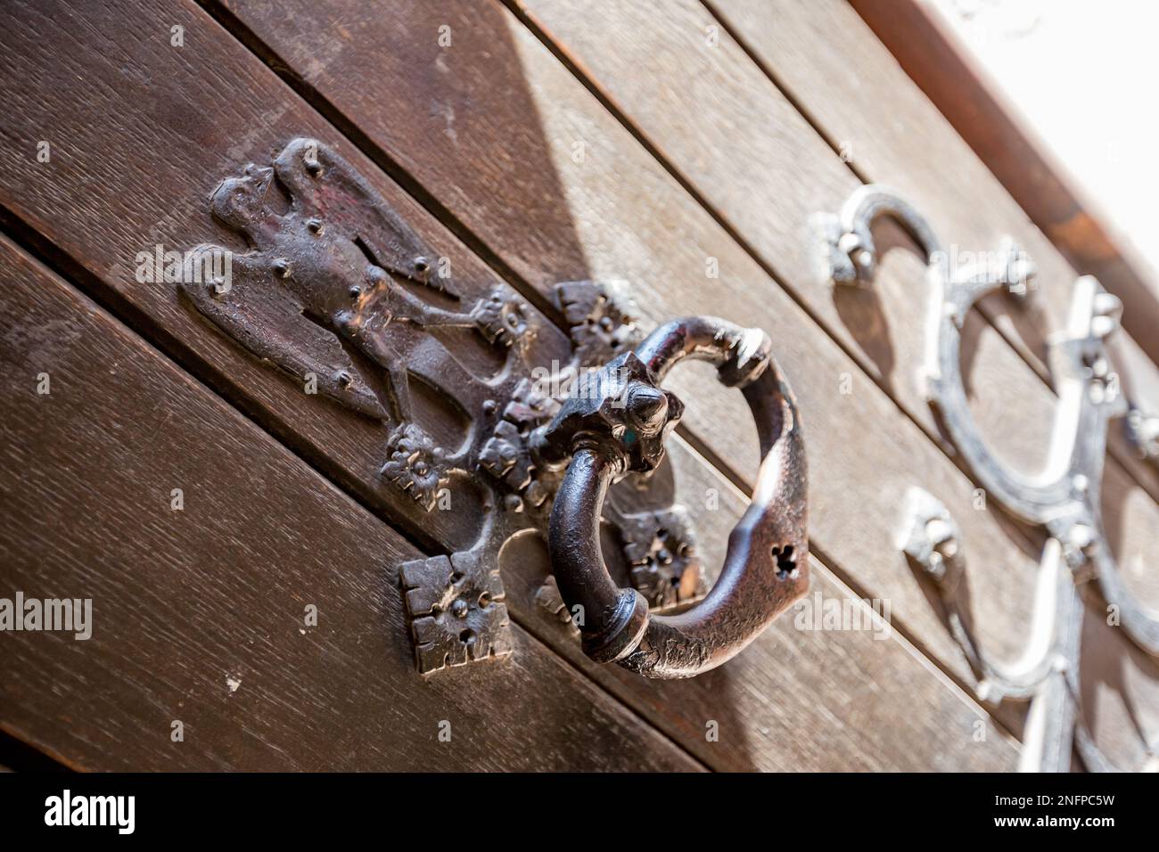 Shallow focus view of old medieval wooden door iron handle, Corvin ...