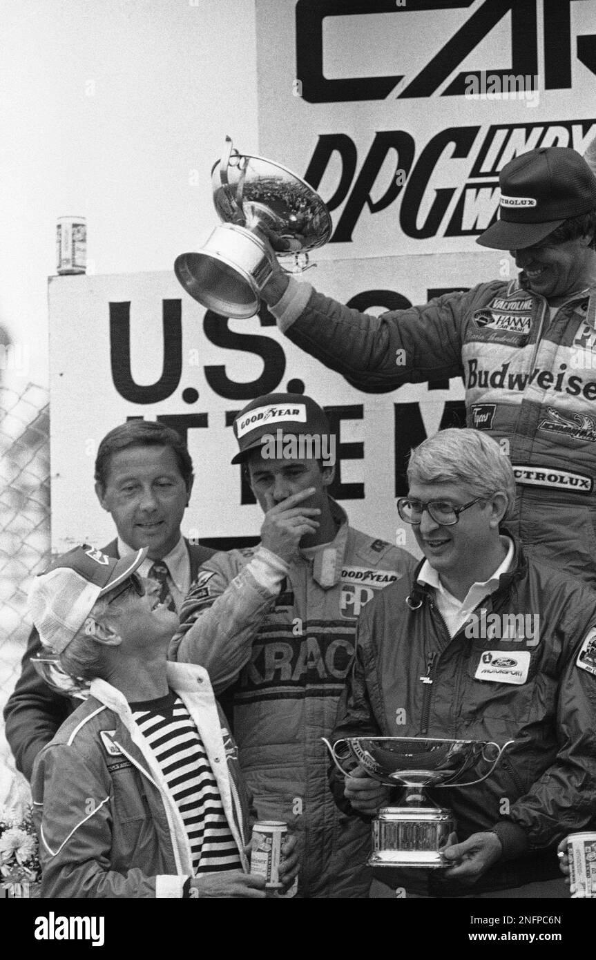 Paul Newman looks up to Geoff Brabham, with his hand to mouth as U.S ...