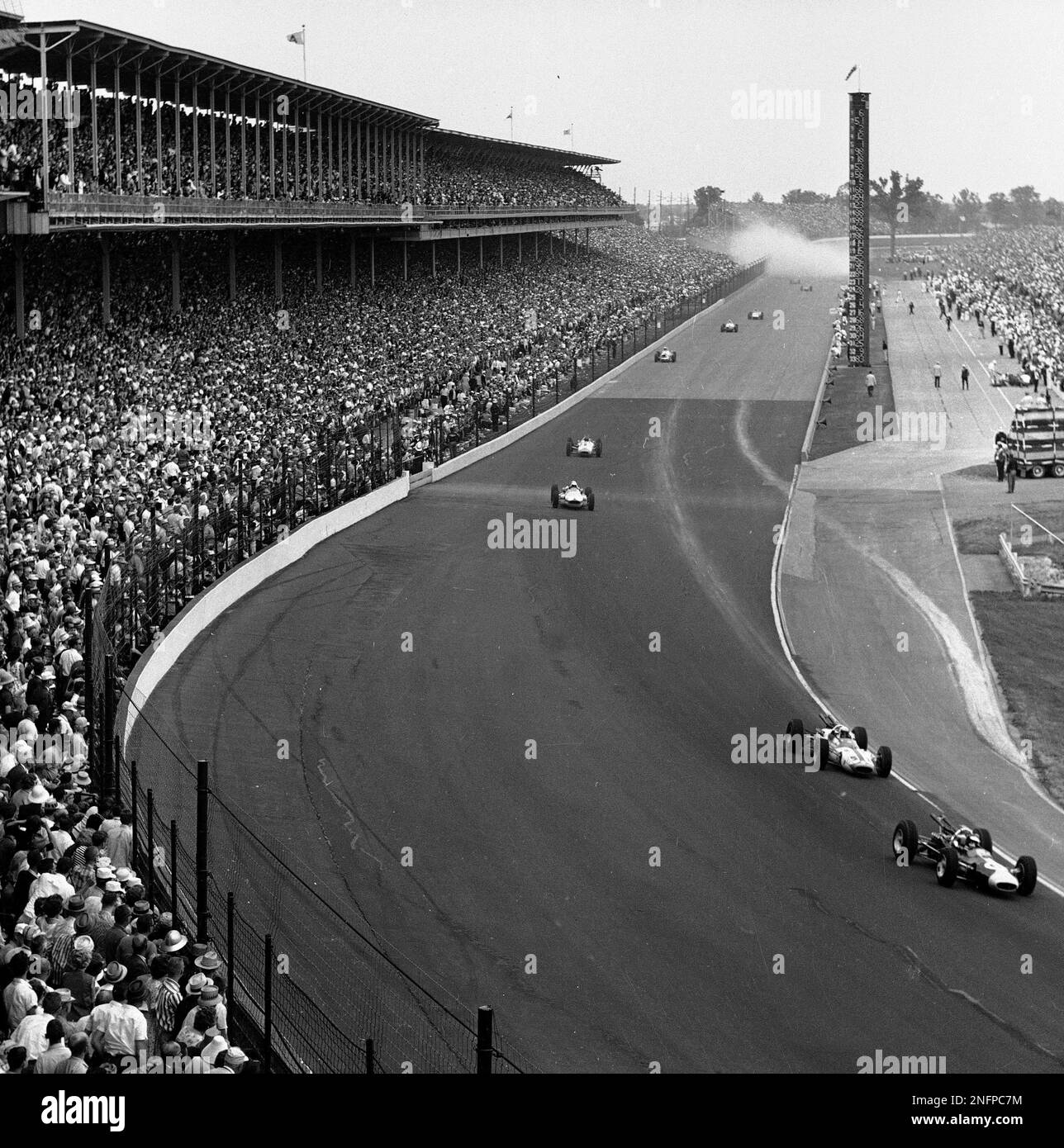 Jim Clark in the Lotus-Ford, leads into the first turn at Indianapolis ...