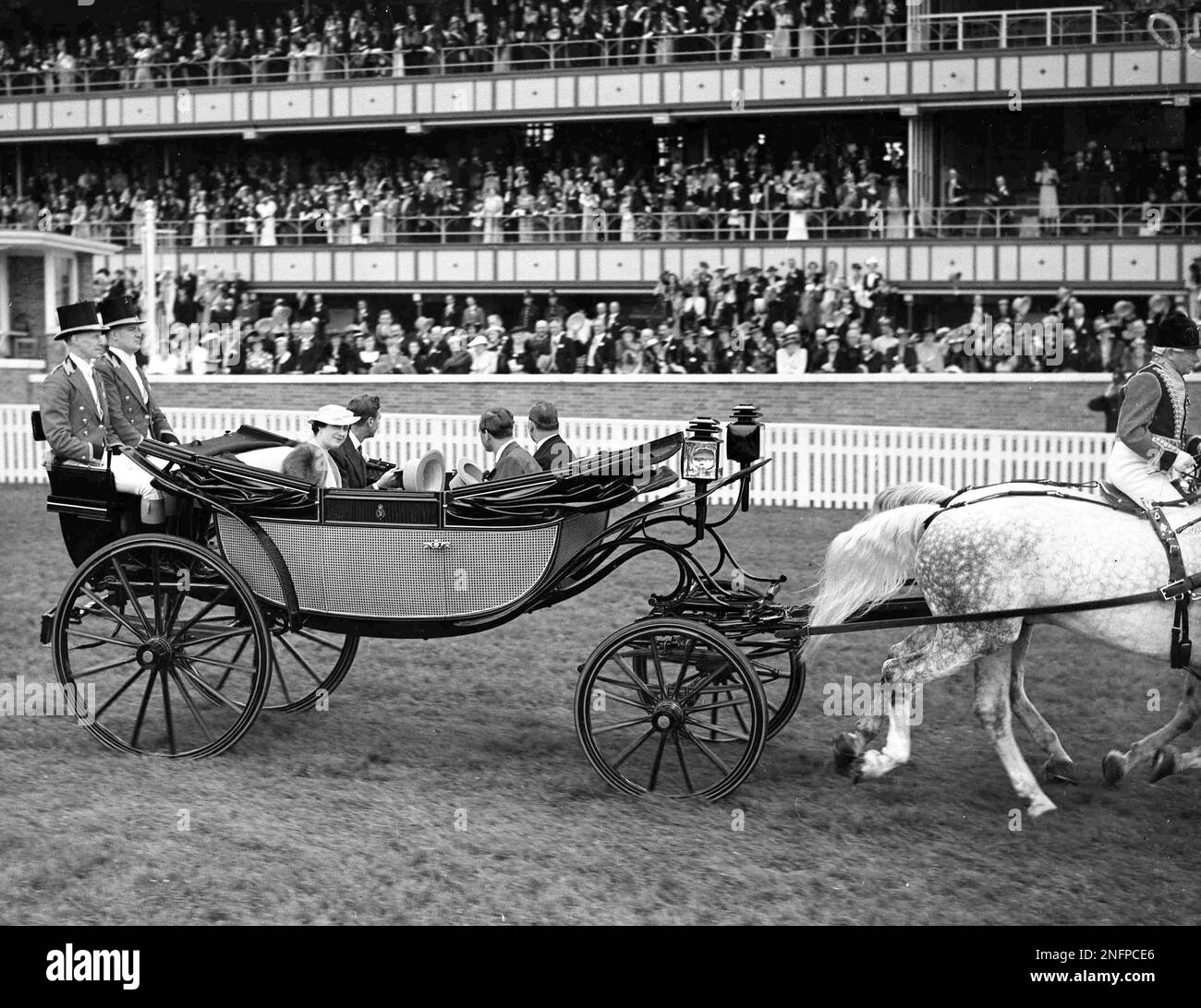 Britain's KIng George VI and his wife Queen Elizabeth drive down the ...