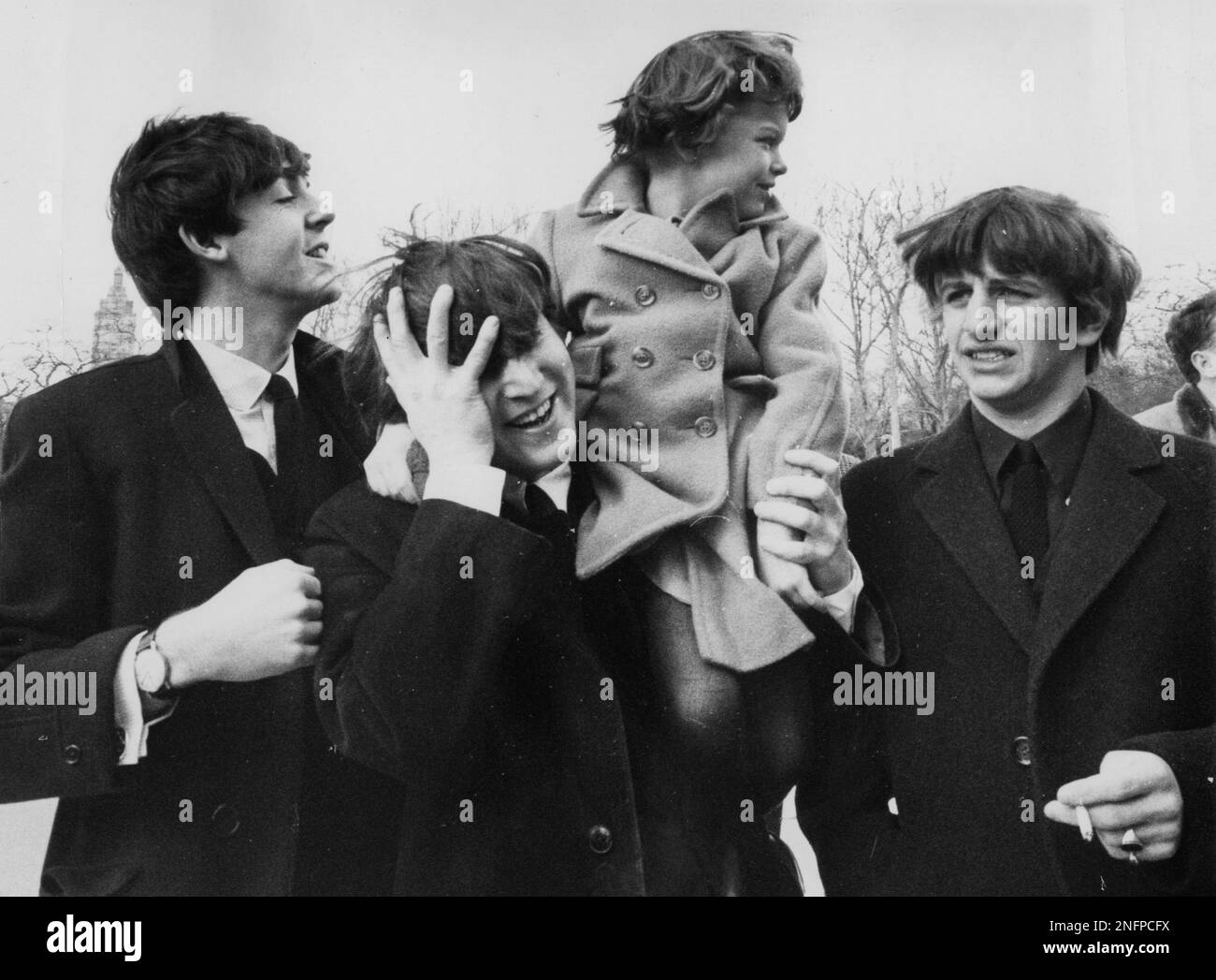 John Lennon, center, holds his forehead as 5-year-old Debbie Fyall, of ...