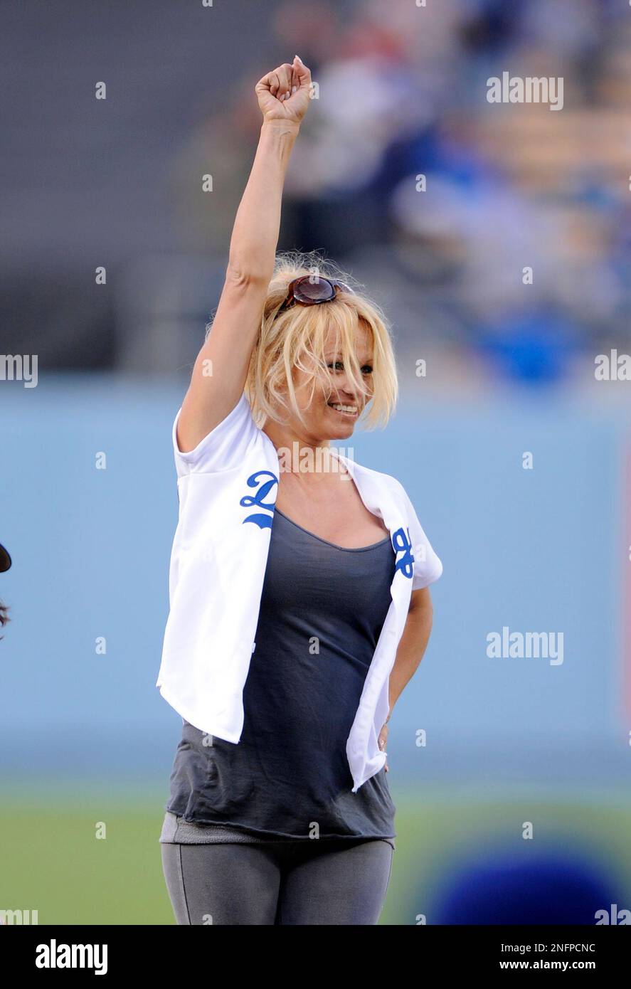 Actress Pamela Anderson reacts after throwing out the ceremonial first ...