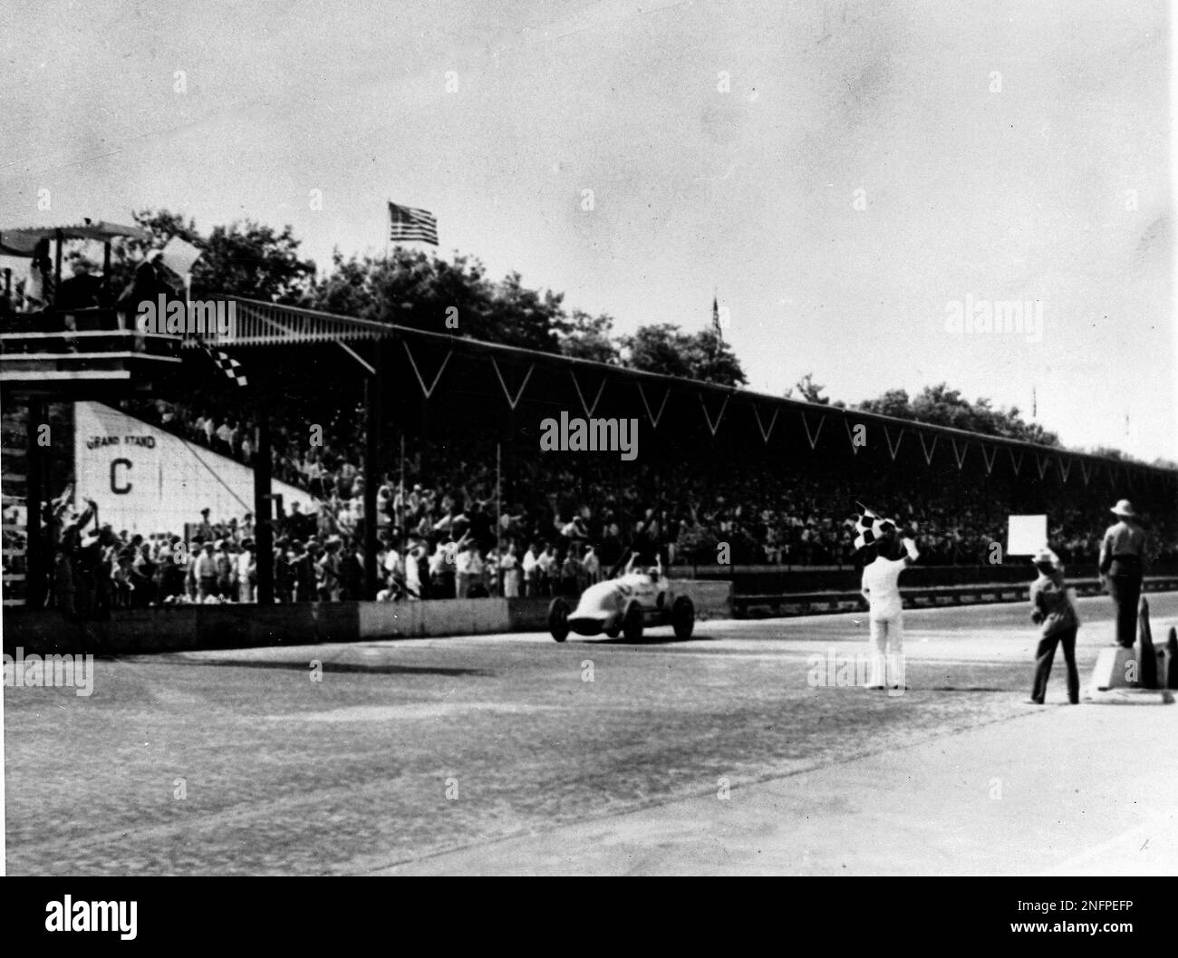 Wilbur Shaw is shown as he crosses the finish line at the Indianapolis ...