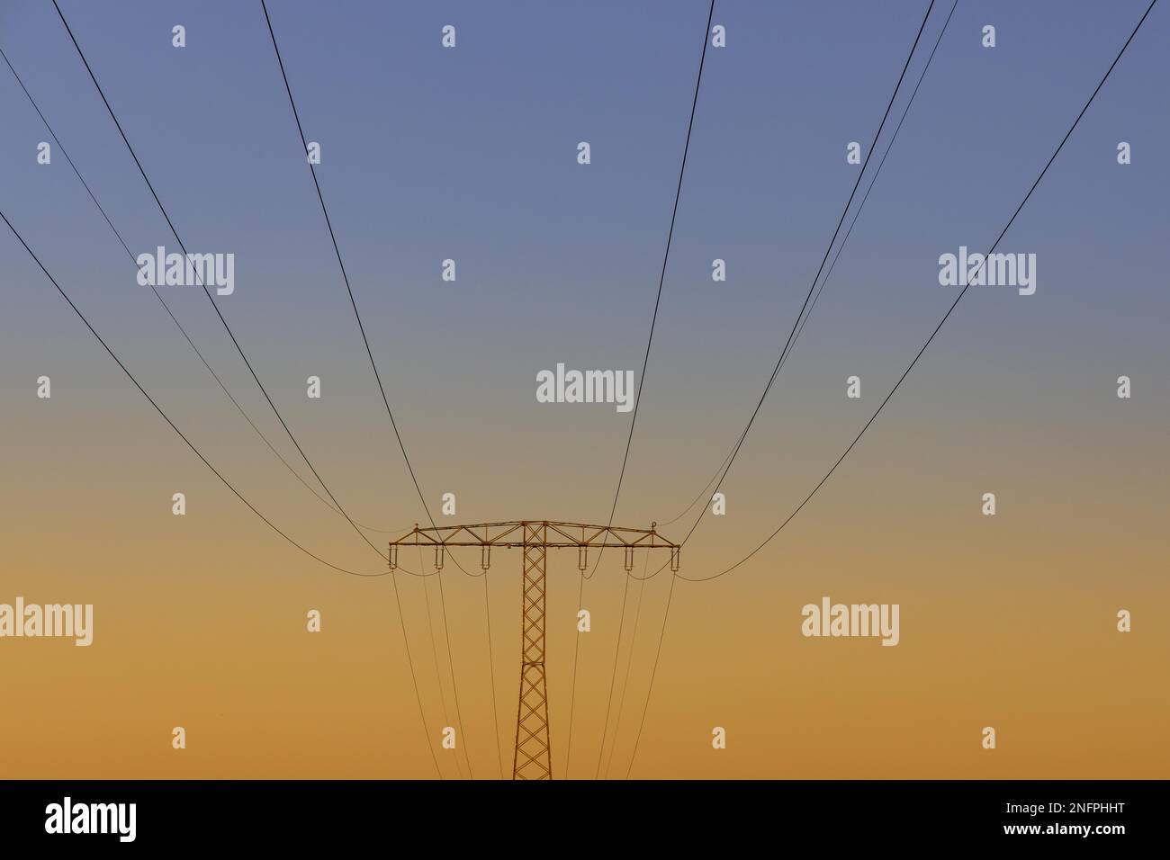 High voltage pylon overhead line in the sunset Stock Photo - Alamy